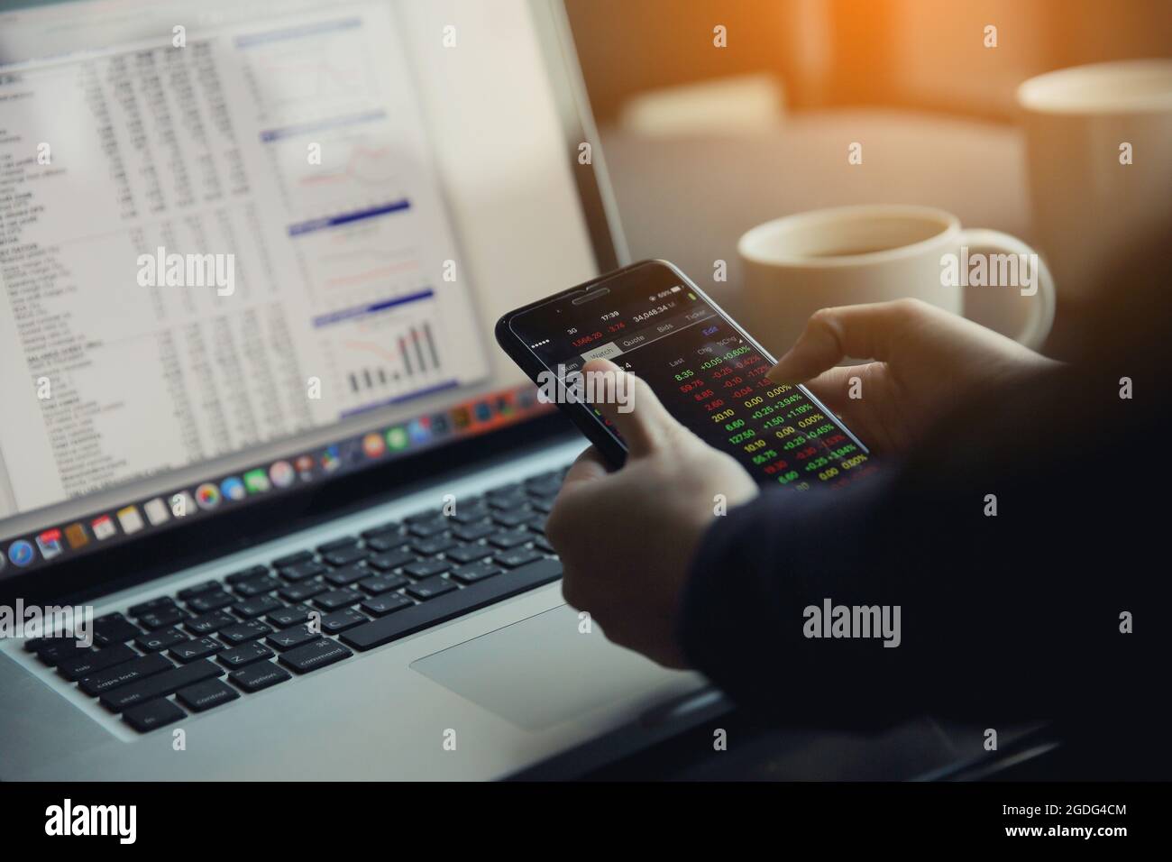 trading online on smartphone and notebook with bussiness woman hand ...