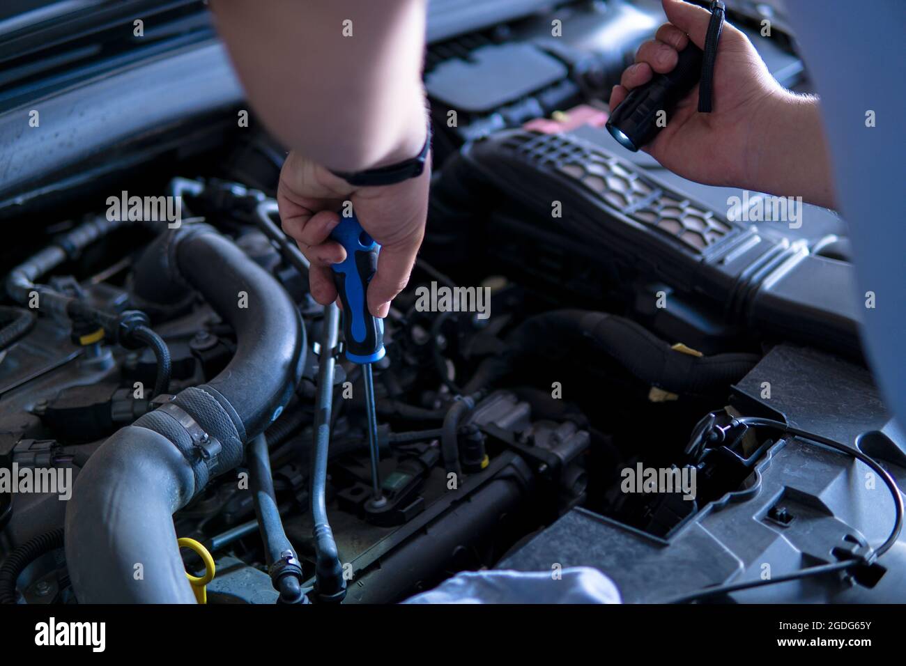 Auto mechanic working and repairing a car engine in a garage wit Stock ...