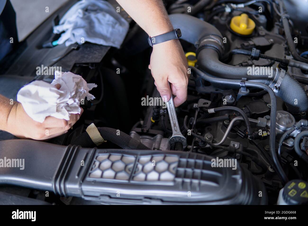 Auto mechanic working repairing a car engine with an open-end sp Stock ...