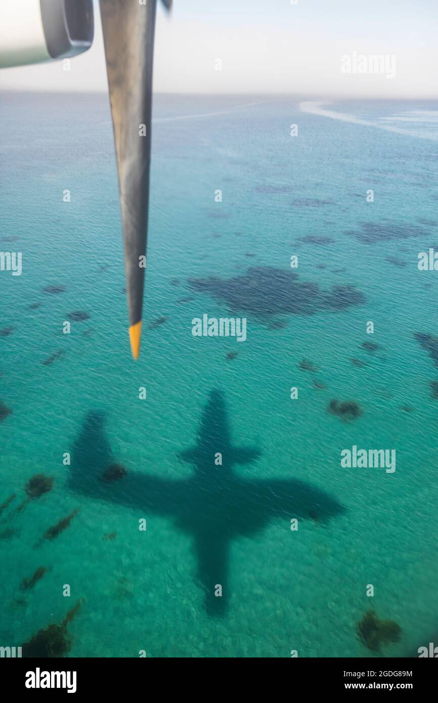 Plane shadow reflected on turquoise water Stock Photo - Alamy
