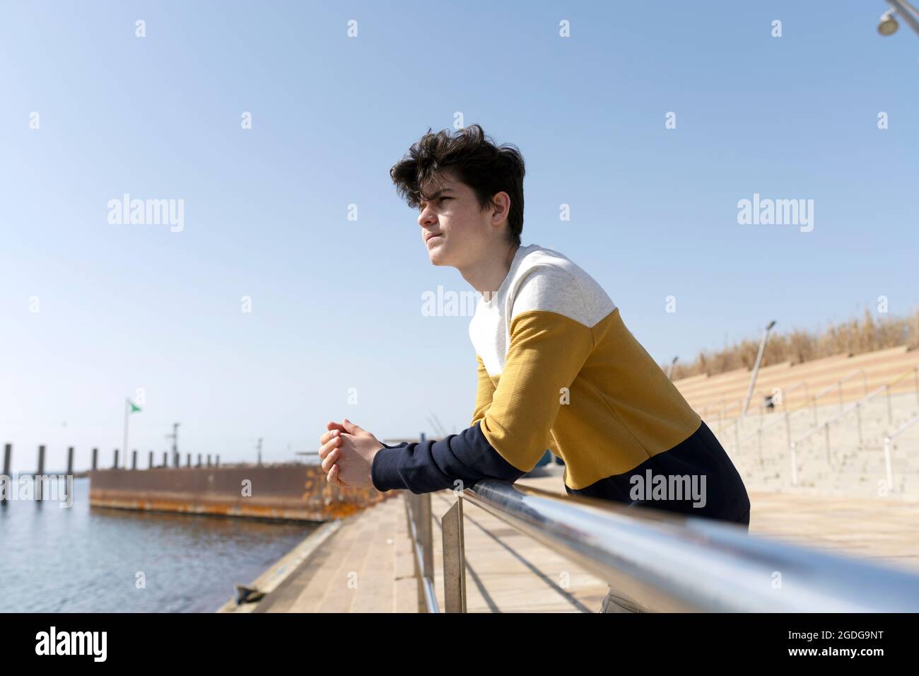 Boy leaning railing outdoors hi-res stock photography and images - Alamy