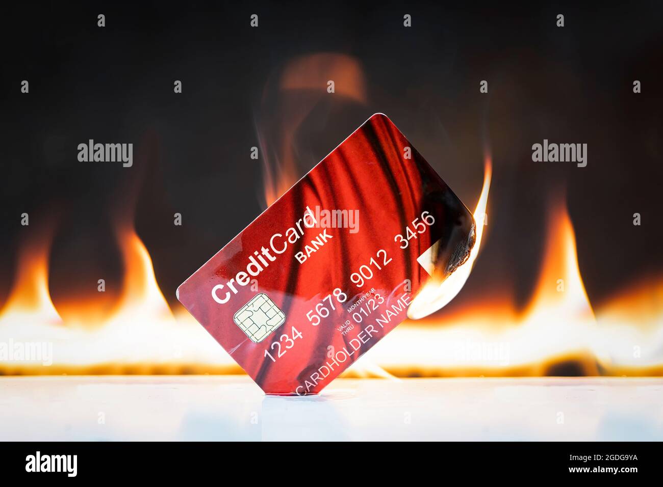 Bank credit card in flames on black background. Concepts of the ...