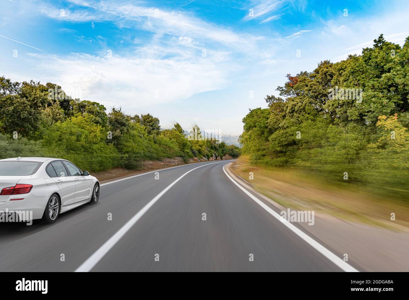 Car is driving along the road. White car on a suburban highway Stock ...