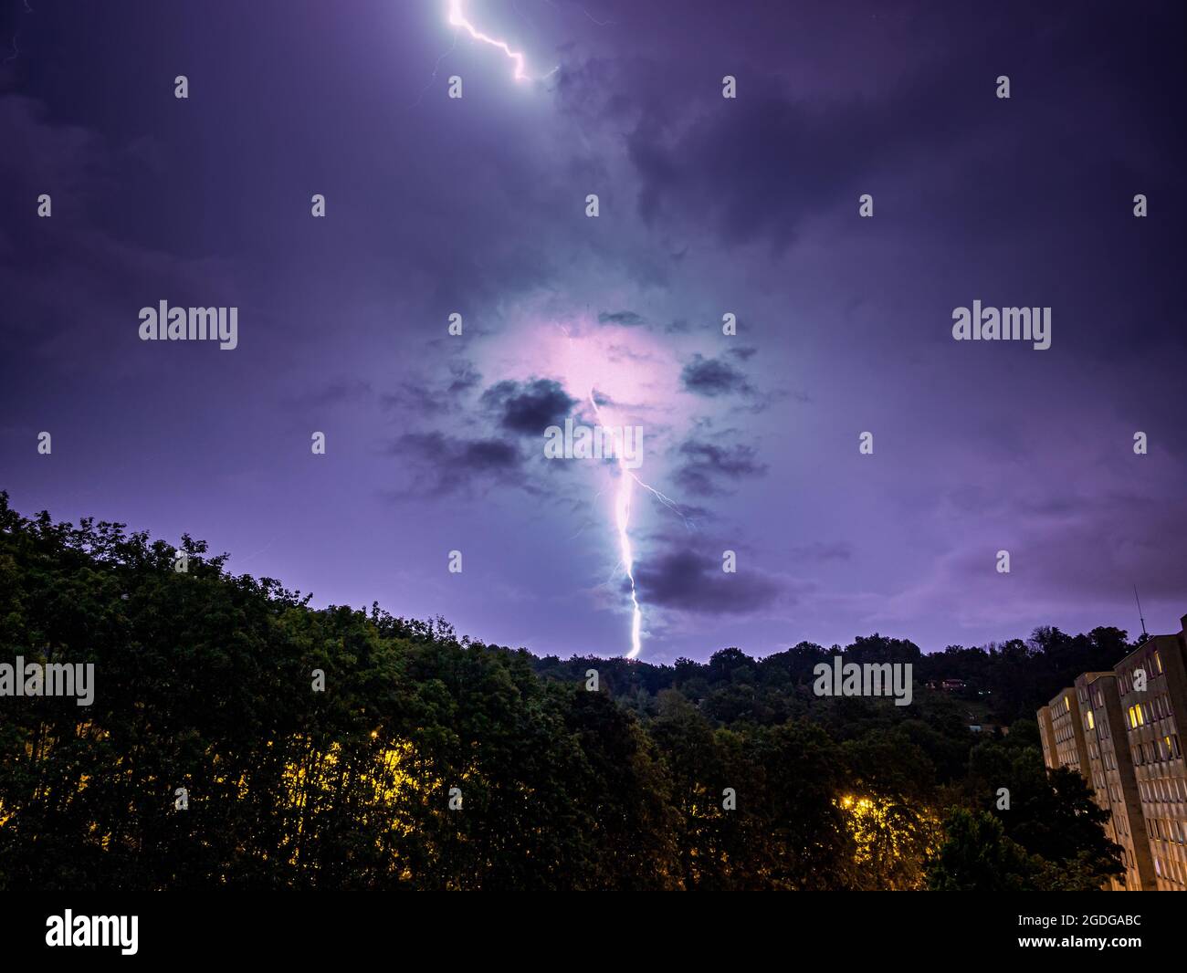Massive lightning strike on a hill on the outskirts of the city - long ...