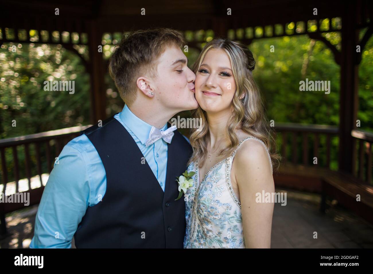 Young man kisses his beautiful partner on her cheek Stock Photo - Alamy