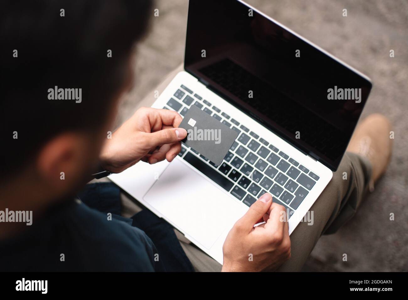 Man using credit card and laptop computer while shopping online ...