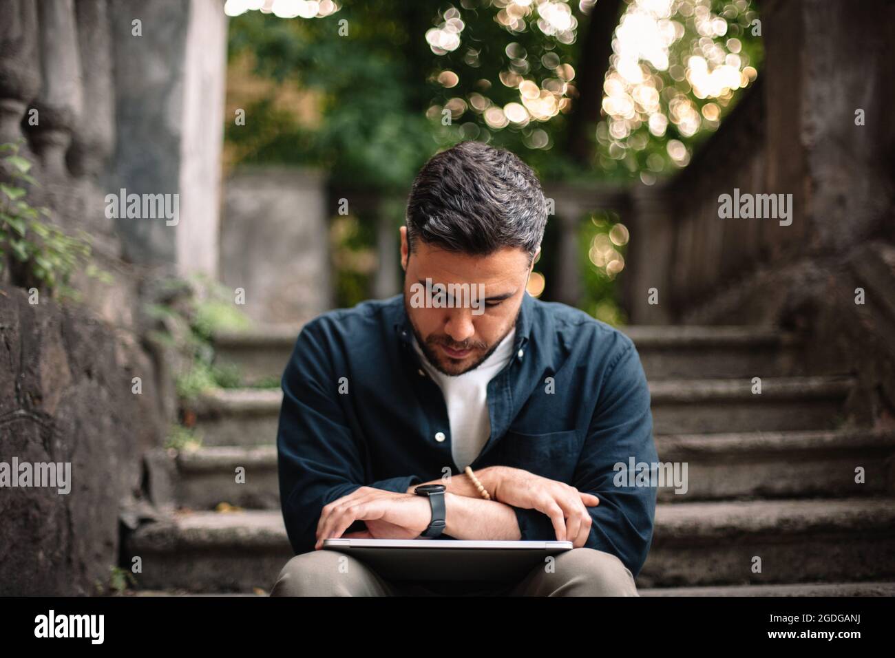 Man laptop looking watch hi-res stock photography and images - Alamy