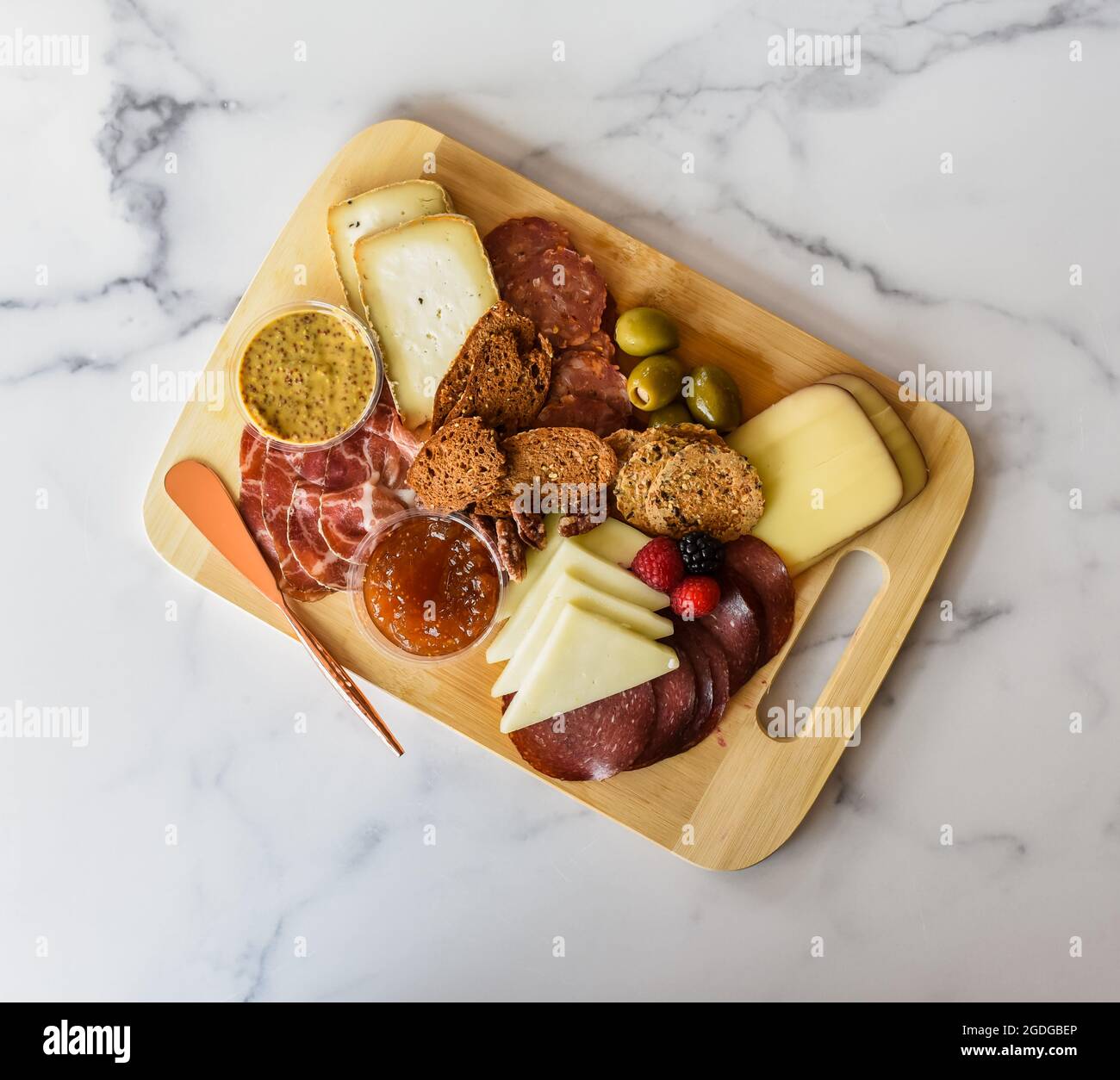 Charcuterie board of meat, cheese and crackers on white marble Stock ...