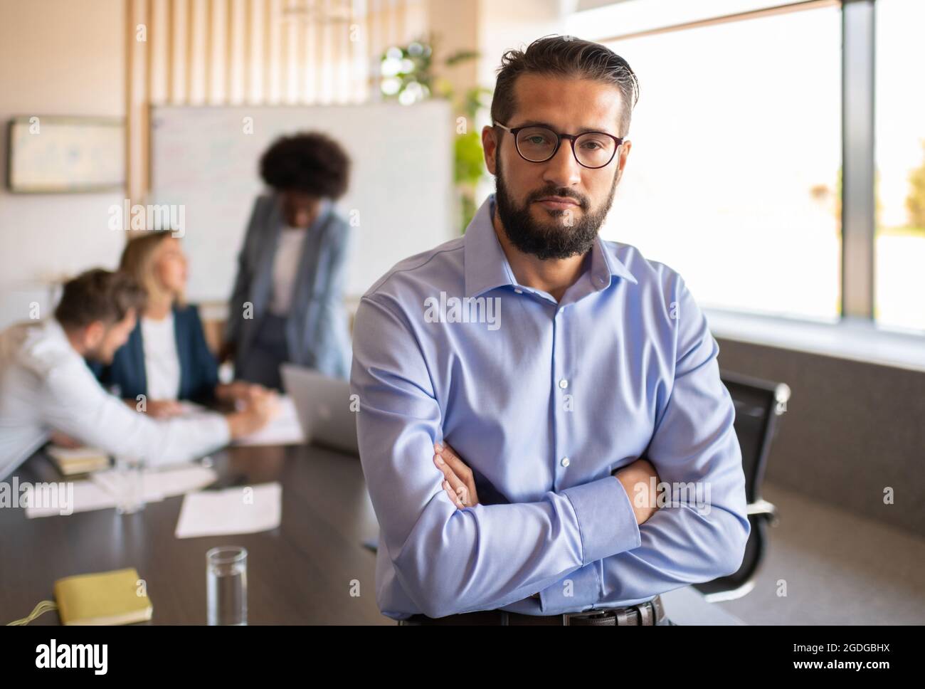 Serious businessman crossing arms hi-res stock photography and images ...