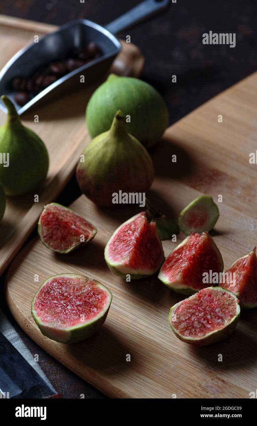 The pieces of sliced figs on the chopping board Stock Photo - Alamy