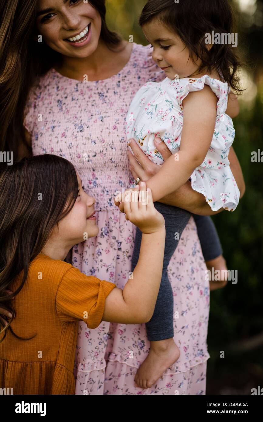 Sisters Holding Hands in Desert Garden in San Diego Stock Photo - Alamy