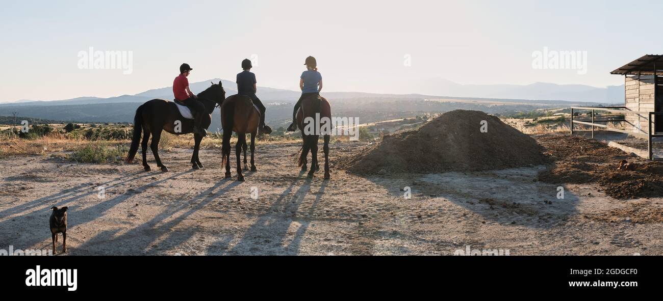 Panoramic view of three people riding a horse and looking at the ...