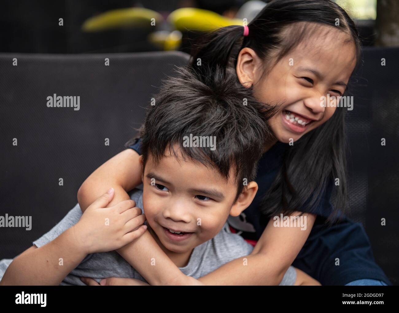 picture of two young Thai siblings playfully embrace Stock Photo - Alamy