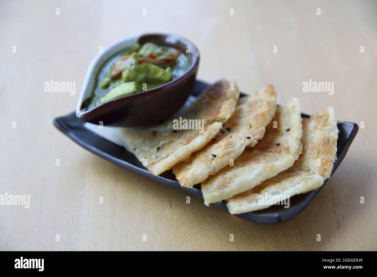 Roti with green curry on wood background Stock Photo - Alamy
