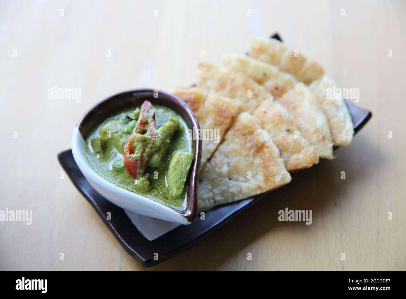 Roti with green curry on wood background Stock Photo - Alamy