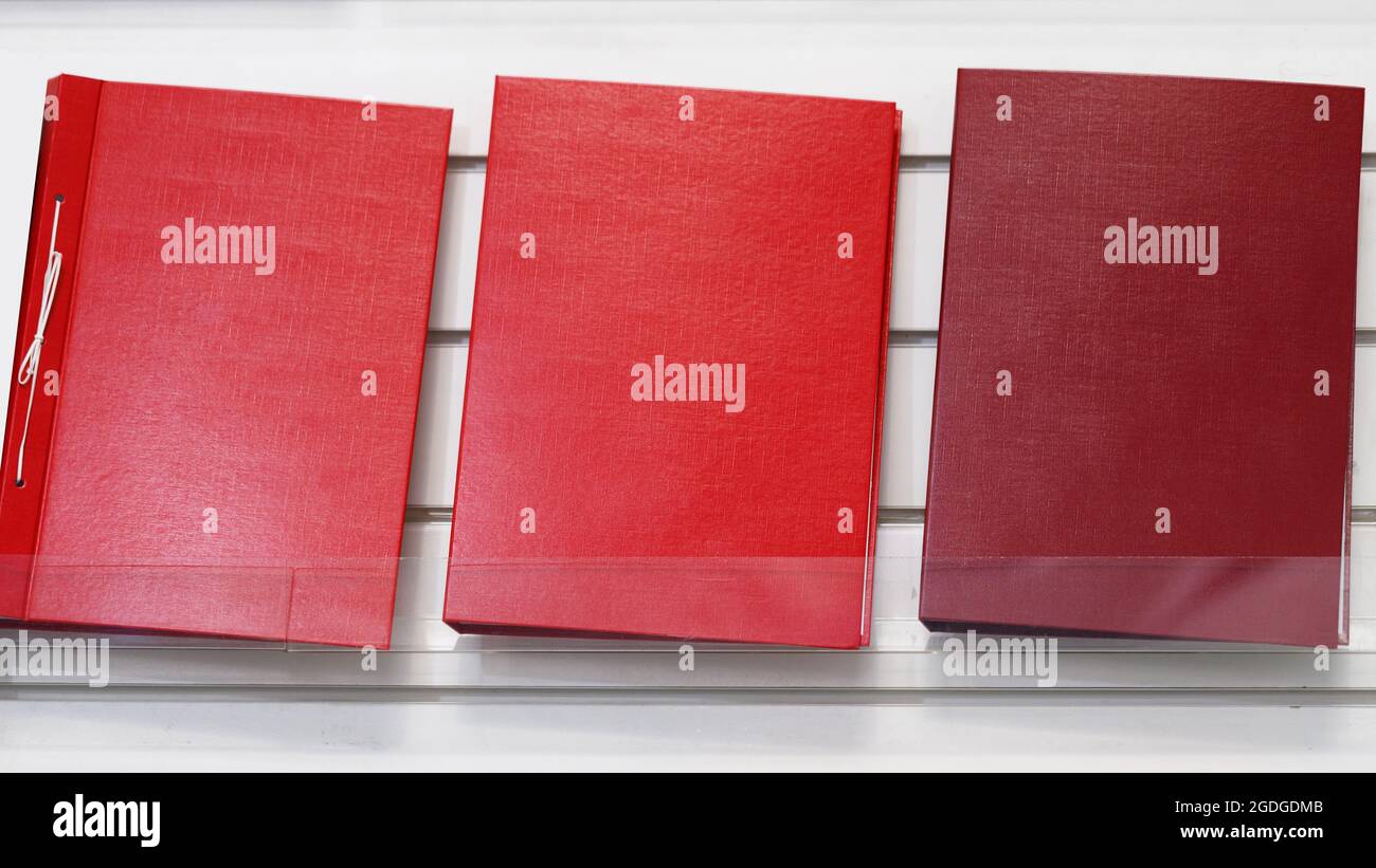 A row of red folders in different shades on a white wall. Free copy ...