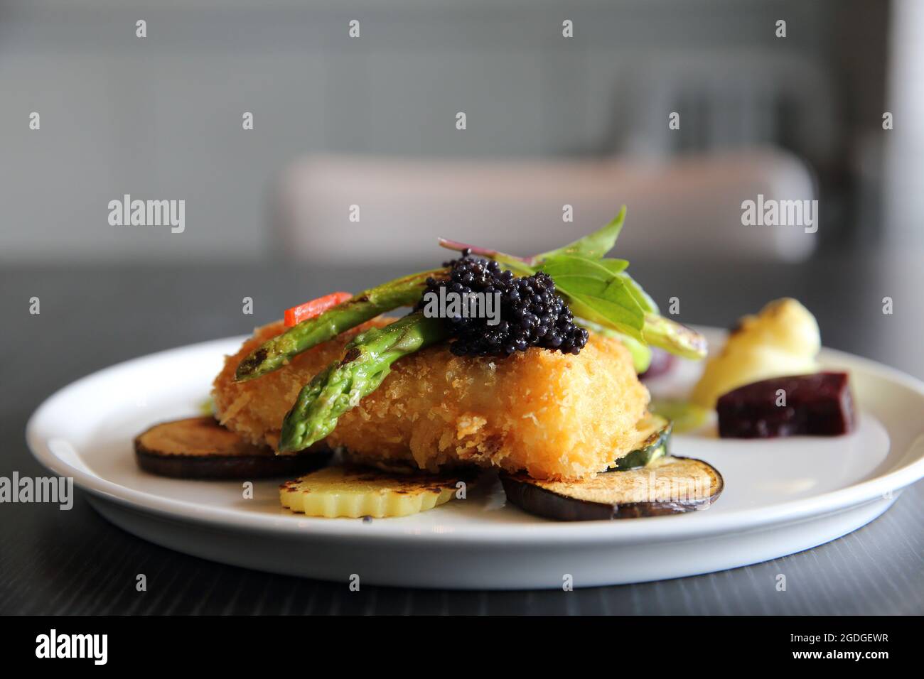 Fried fish fillet with green sauce Stock Photo - Alamy