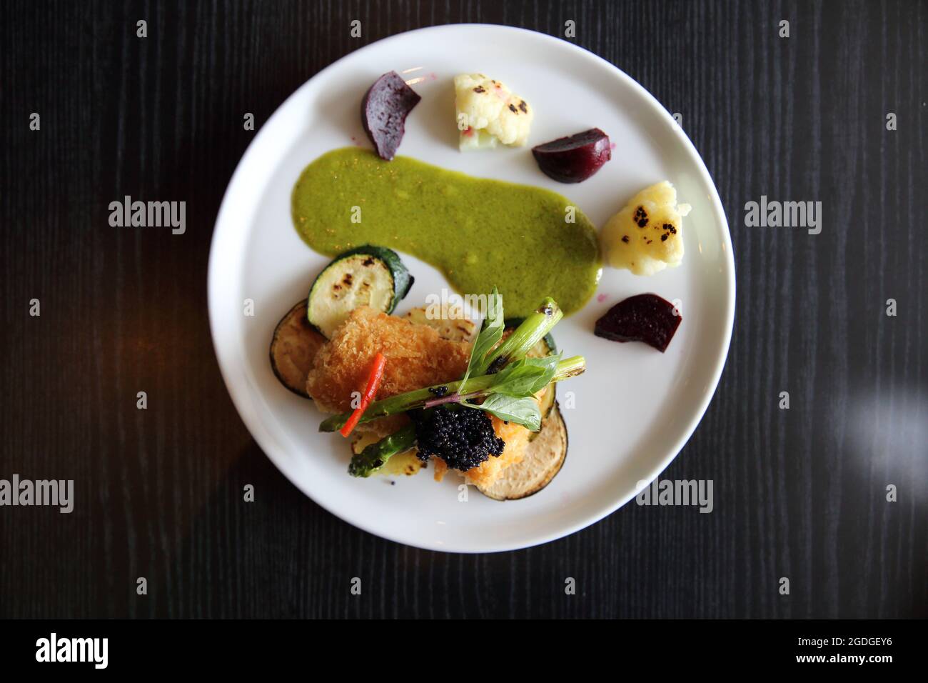 Fried fish fillet with green sauce Stock Photo - Alamy