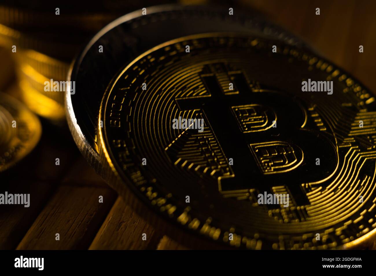 Closeup shot of gold and silver bitcoins scattered on a surface ...