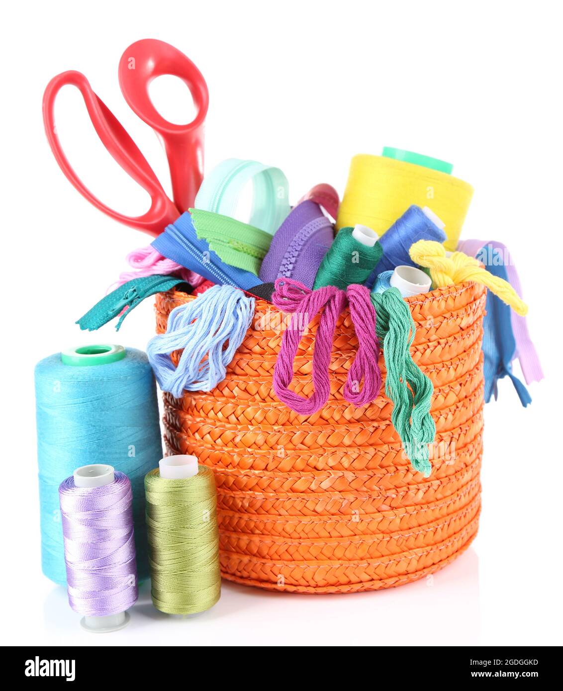 Round orange box full of multicoloured threads and everything necessary ...