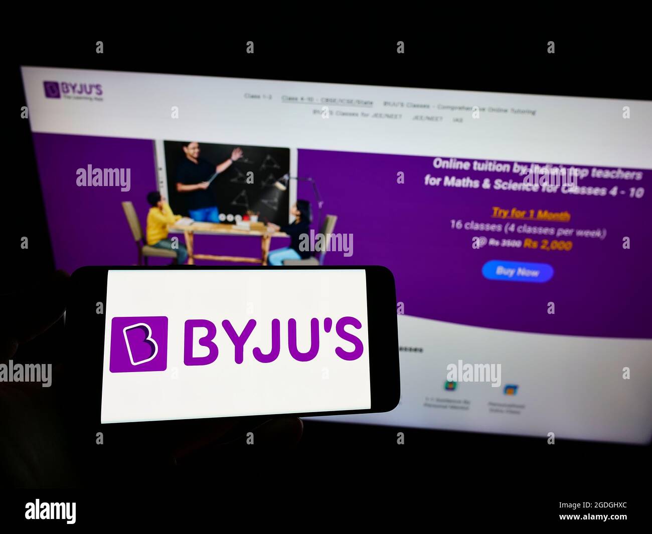 Person holding mobile phone with logo of Indian e-learning software ...