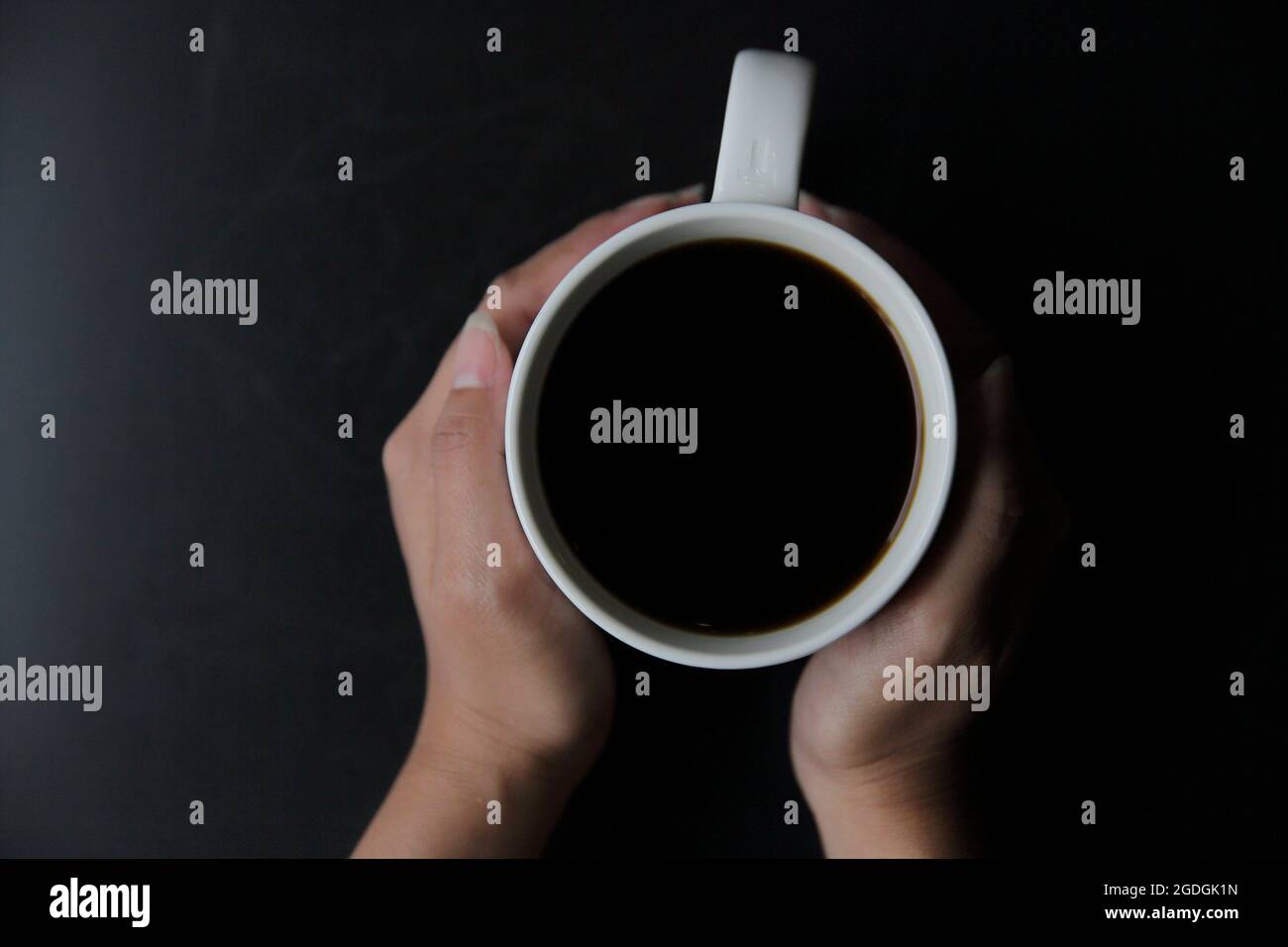 Black coffee with hand on wood background in coffee shop Stock Photo ...