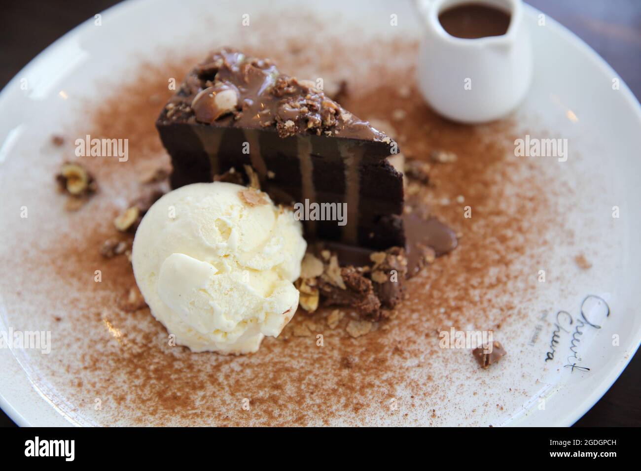 Dark chocolate cake with vanilla ice cream dessert Stock Photo - Alamy