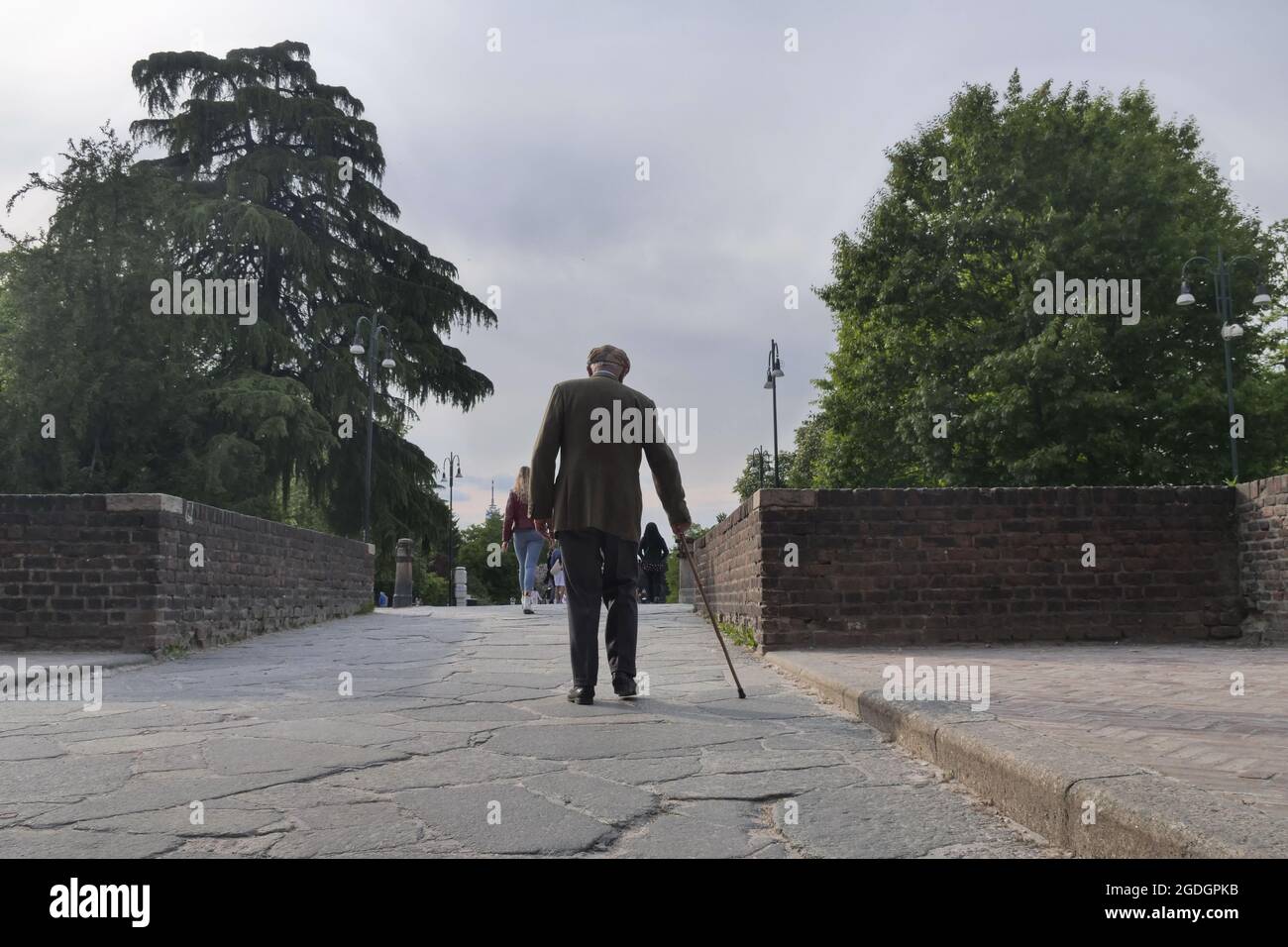 Old man walking with his cane in public park Stock Photo - Alamy