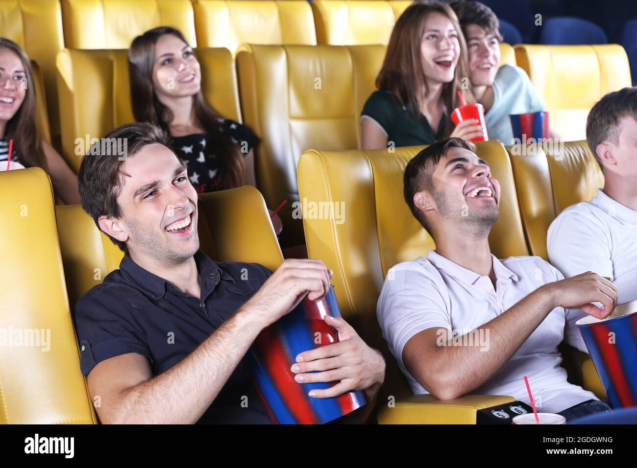 Young people watching movie in cinema Stock Photo - Alamy