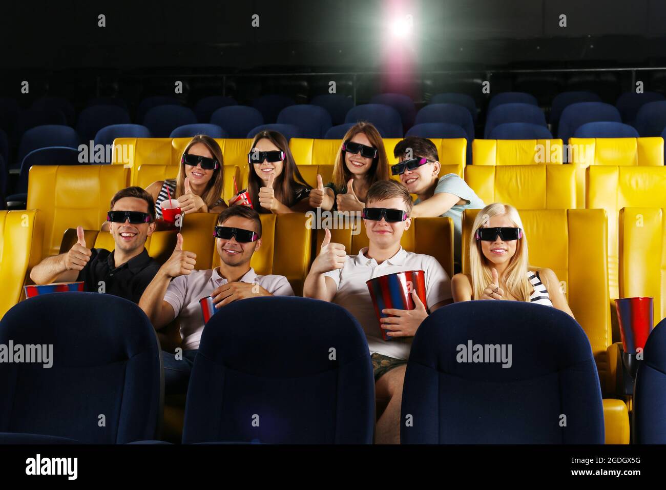 Young people watching movie in cinema Stock Photo - Alamy