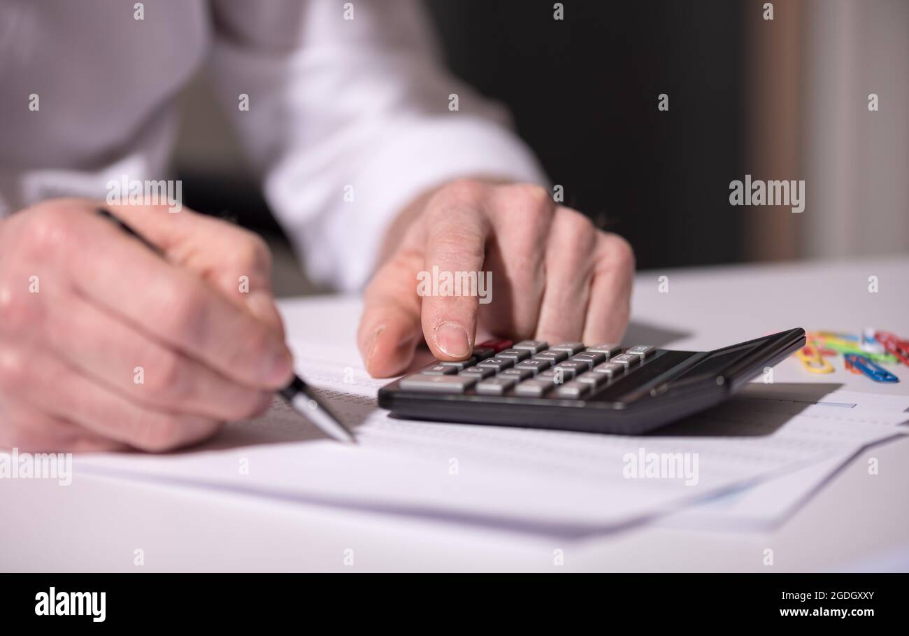 Male hand using calculator, accounting concept Stock Photo - Alamy