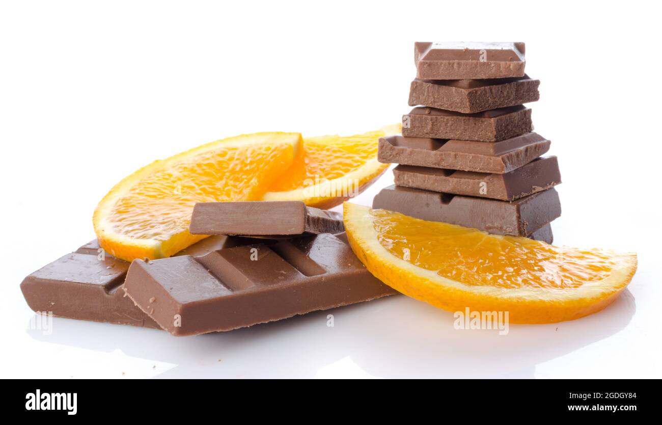 Chocolate squares with fresh orange slices, isolated on white Stock ...
