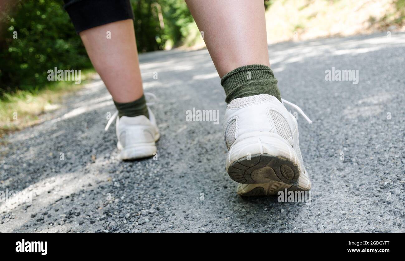 Back view of hiker legs walking on a path Stock Photo - Alamy
