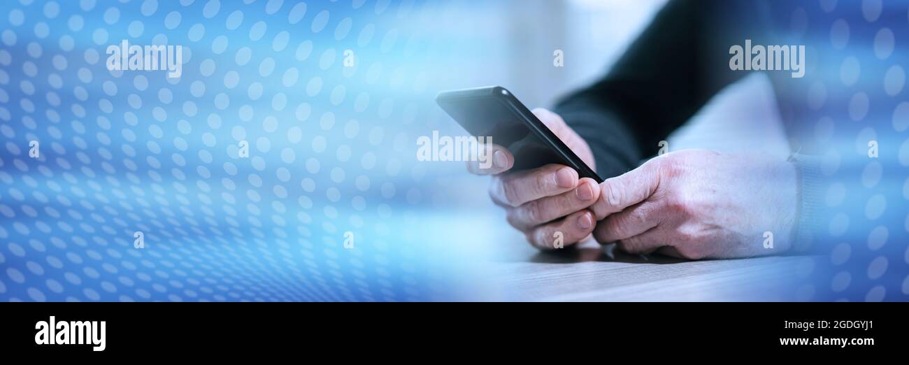 Male hands using his mobile phone; panoramic banner Stock Photo - Alamy