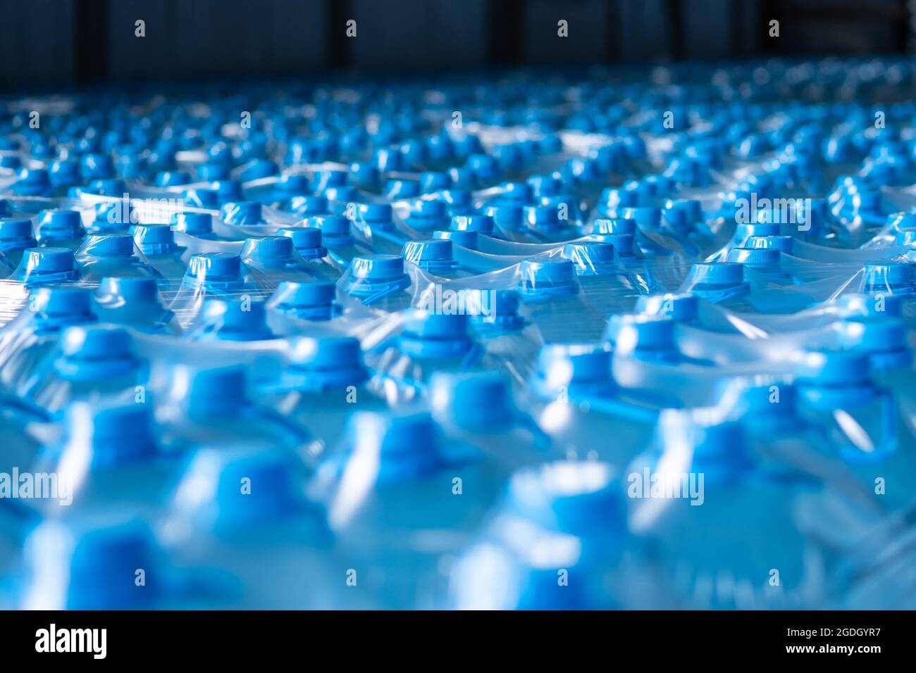 Background image of blue plastic bottles with blue cap and handle in ...