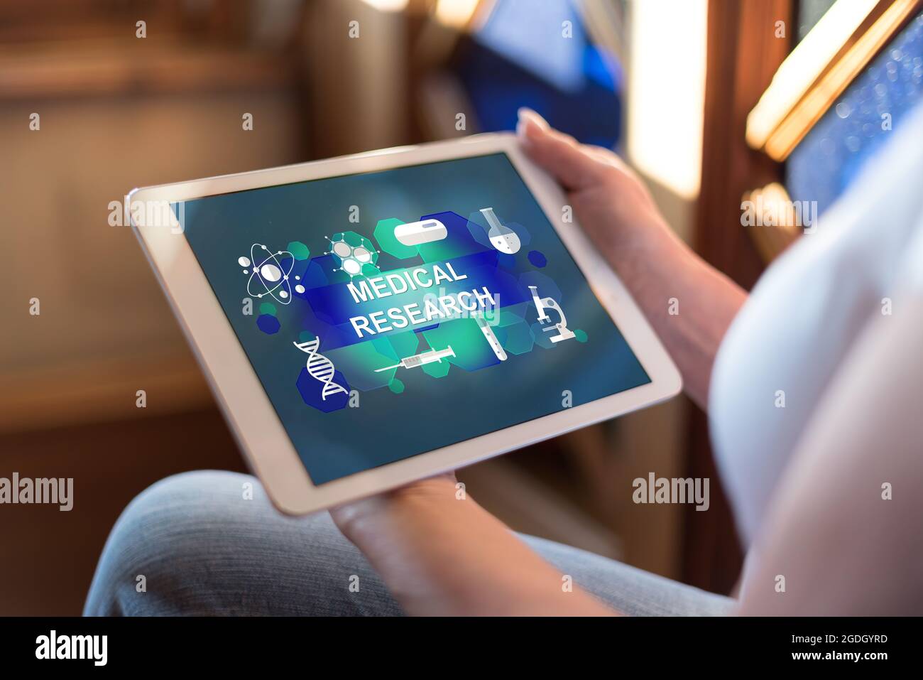 Woman holding a tablet showing medical research concept Stock Photo - Alamy