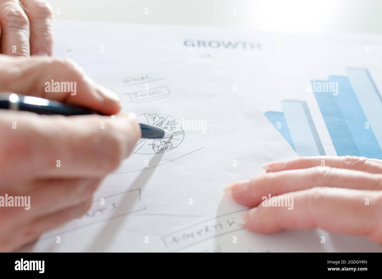 Hand pointing a pen on a diagram, closeup Stock Photo - Alamy