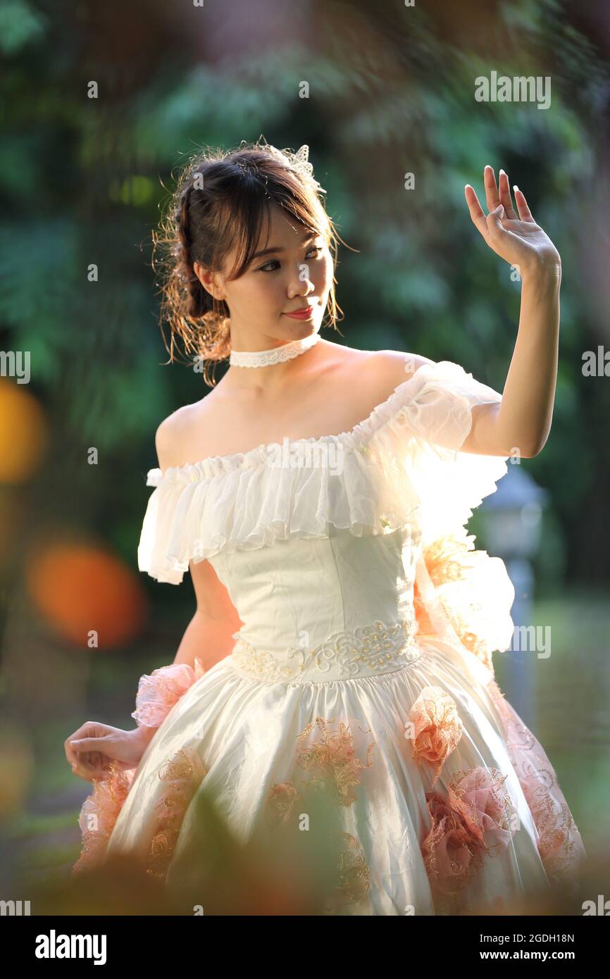 Asian Bride in white dress in outdoor Stock Photo - Alamy