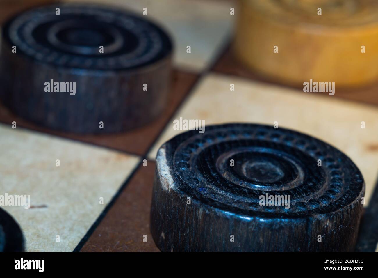 Closeup shot of a checkers board and wooden game pieces on it Stock ...