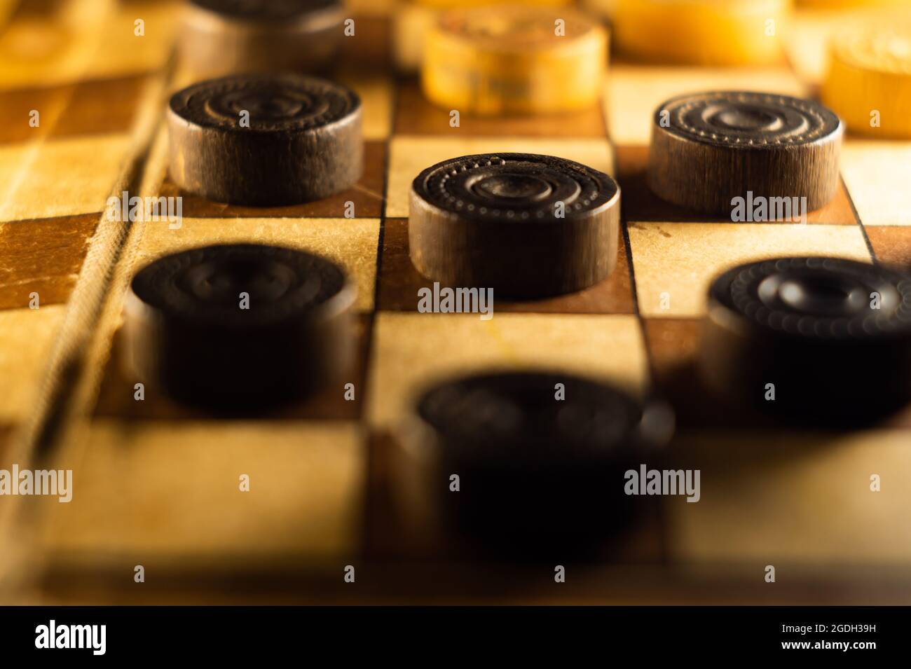 Closeup shot of a checkers board and wooden game pieces on it Stock ...