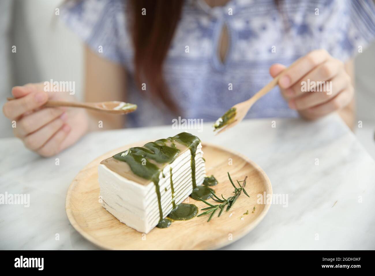 Young Asian Woman eating Green tea crape cake sweet food Stock Photo ...