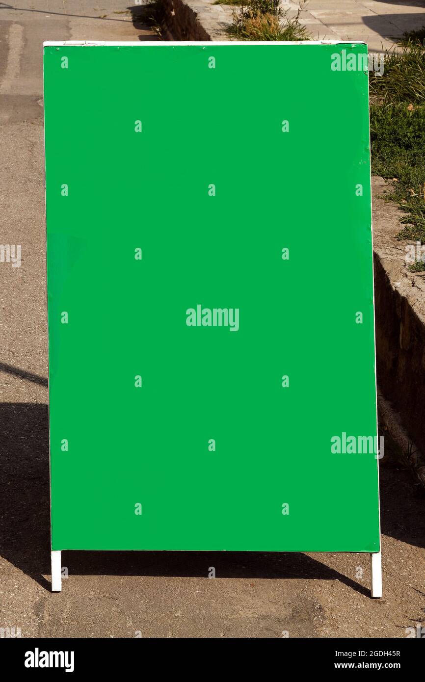 Empty blank green color board outside in public park Stock Photo - Alamy