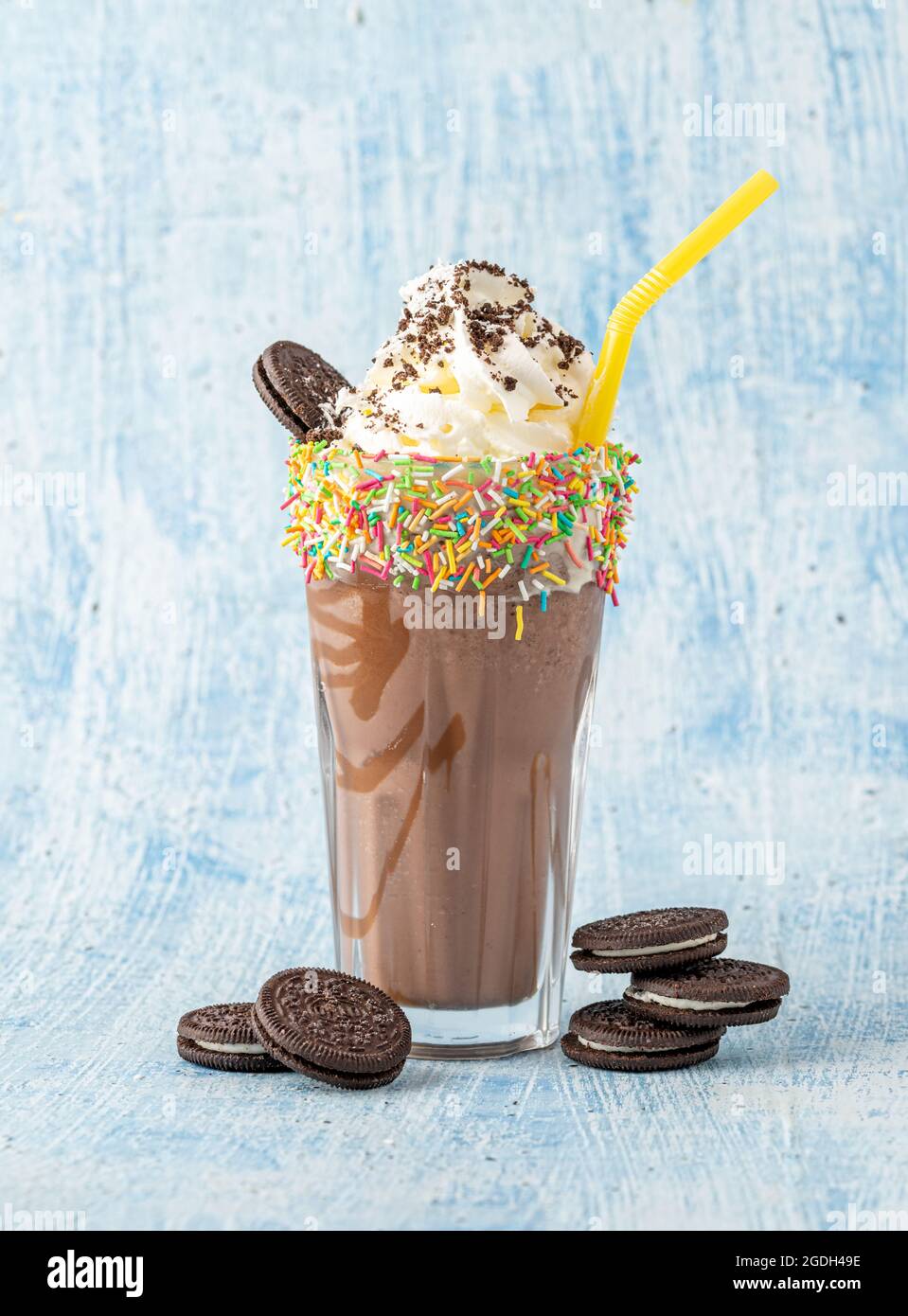 Cream and chocolate milkshake on blue background Stock Photo - Alamy