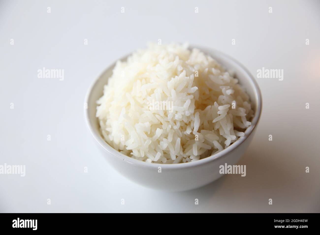 Cooked rice in bowl isolated in white background Stock Photo - Alamy