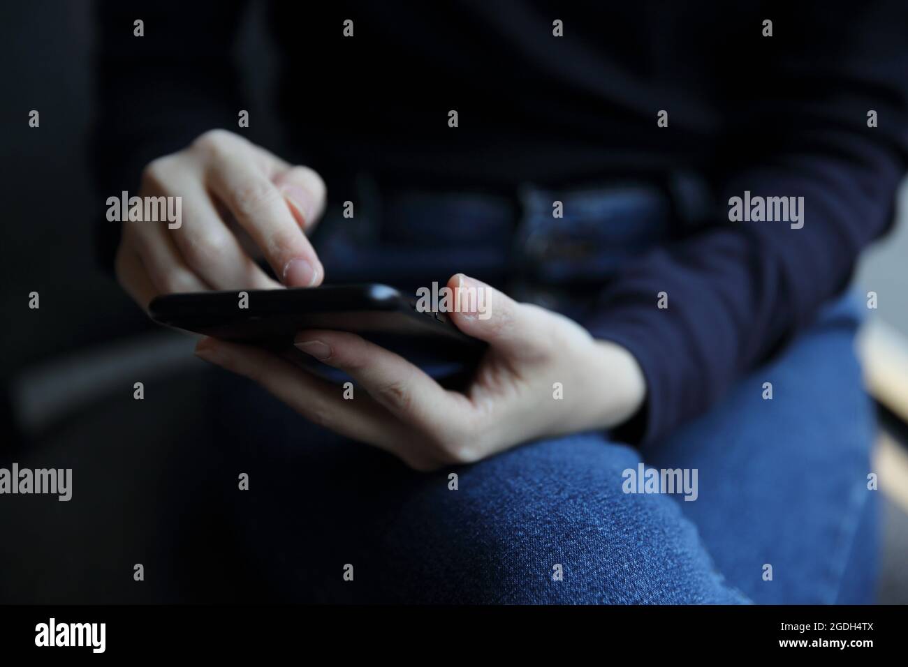 Asian female with hands typing text message Stock Photo - Alamy