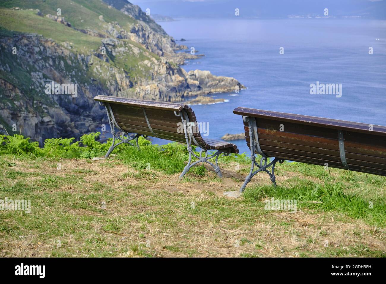 Wooden benches on the shore of the blue lake under the sky Stock Photo ...