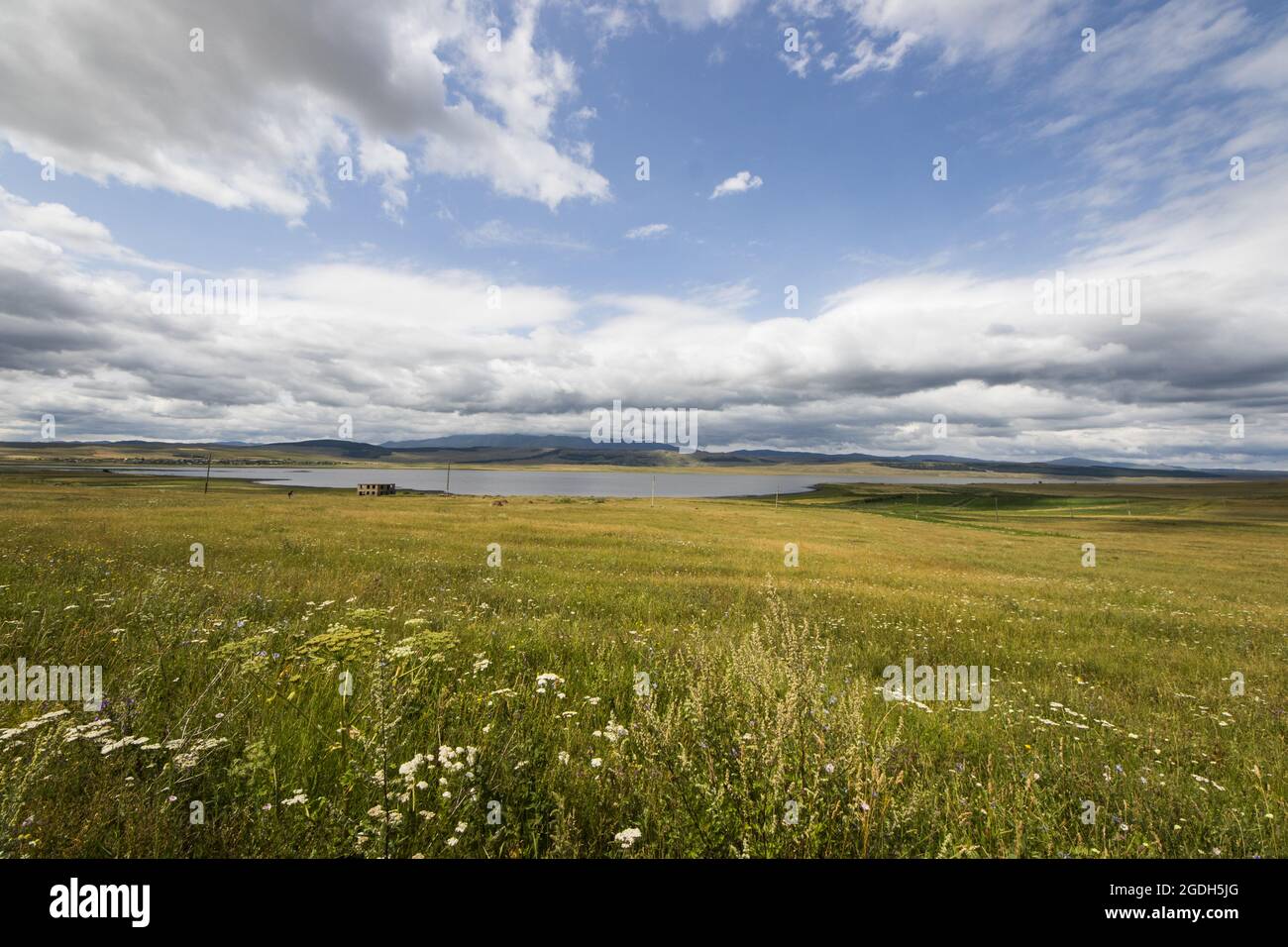 Landscape and view of lake in Tsalka, Georgia. Green field and clouds ...