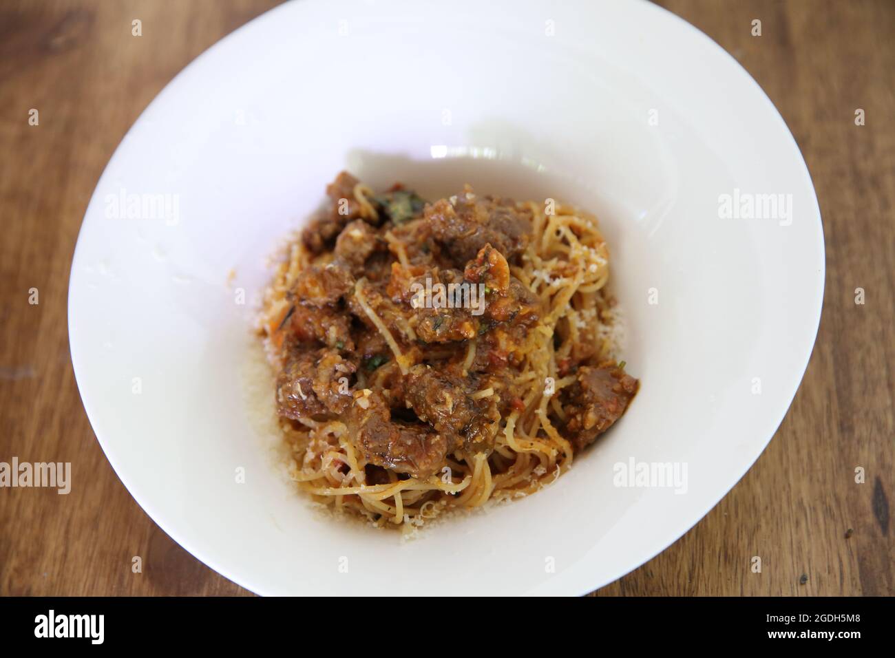 Beef stew spaghetti on wood background Stock Photo - Alamy