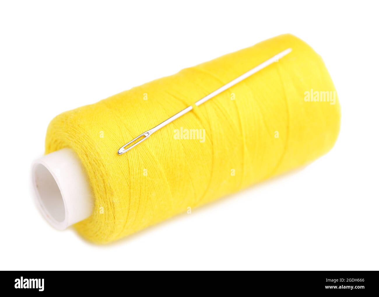 Needle and spool of thread isolated on white Stock Photo - Alamy