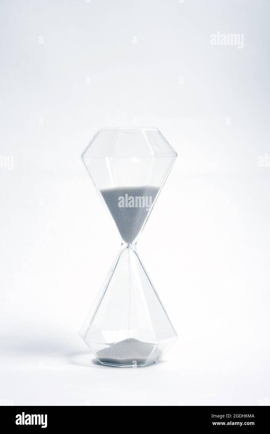 Hourglass on a white background, passing time Stock Photo - Alamy